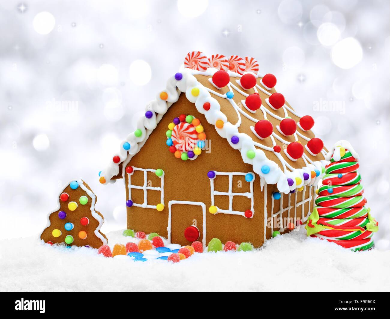 Gingerbread house in snow with twinkling silver light background Stock ...