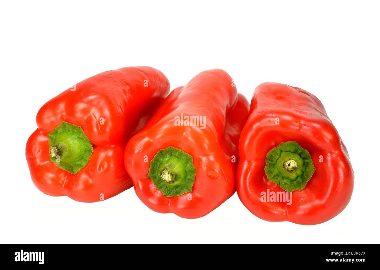 Three red peppers on a white background Stock Photo - Alamy