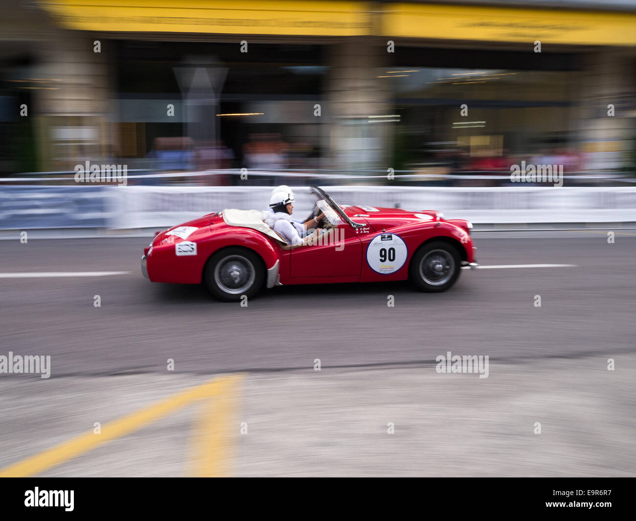 A red car with number 90 races on the streets of Montreux, Switzerland ...