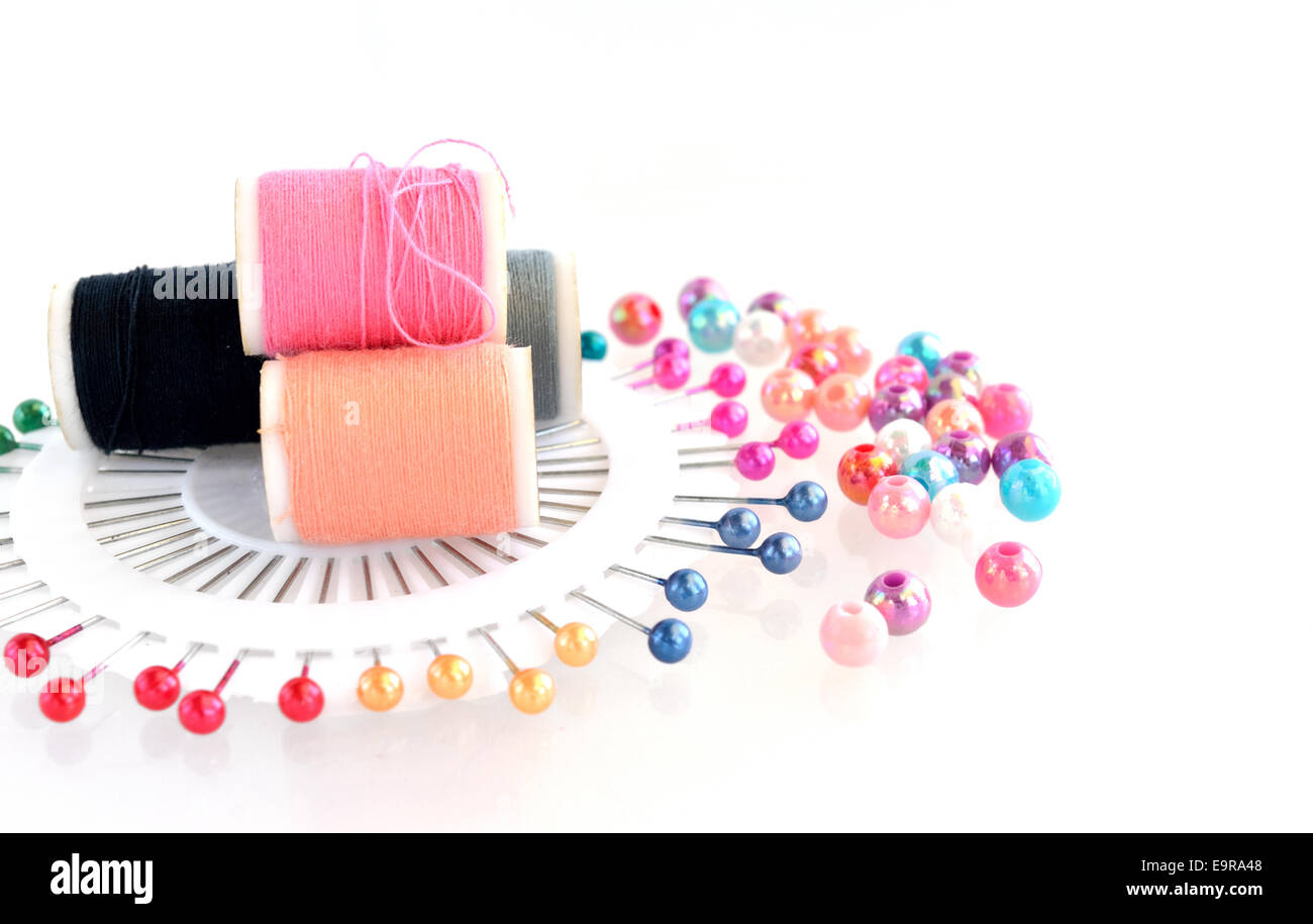 beads, pin, threads accessories on white background Stock Photo - Alamy