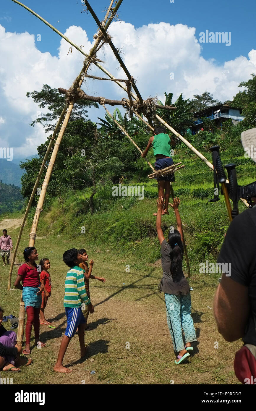 Kids playing on a swing Stock Photo - Alamy