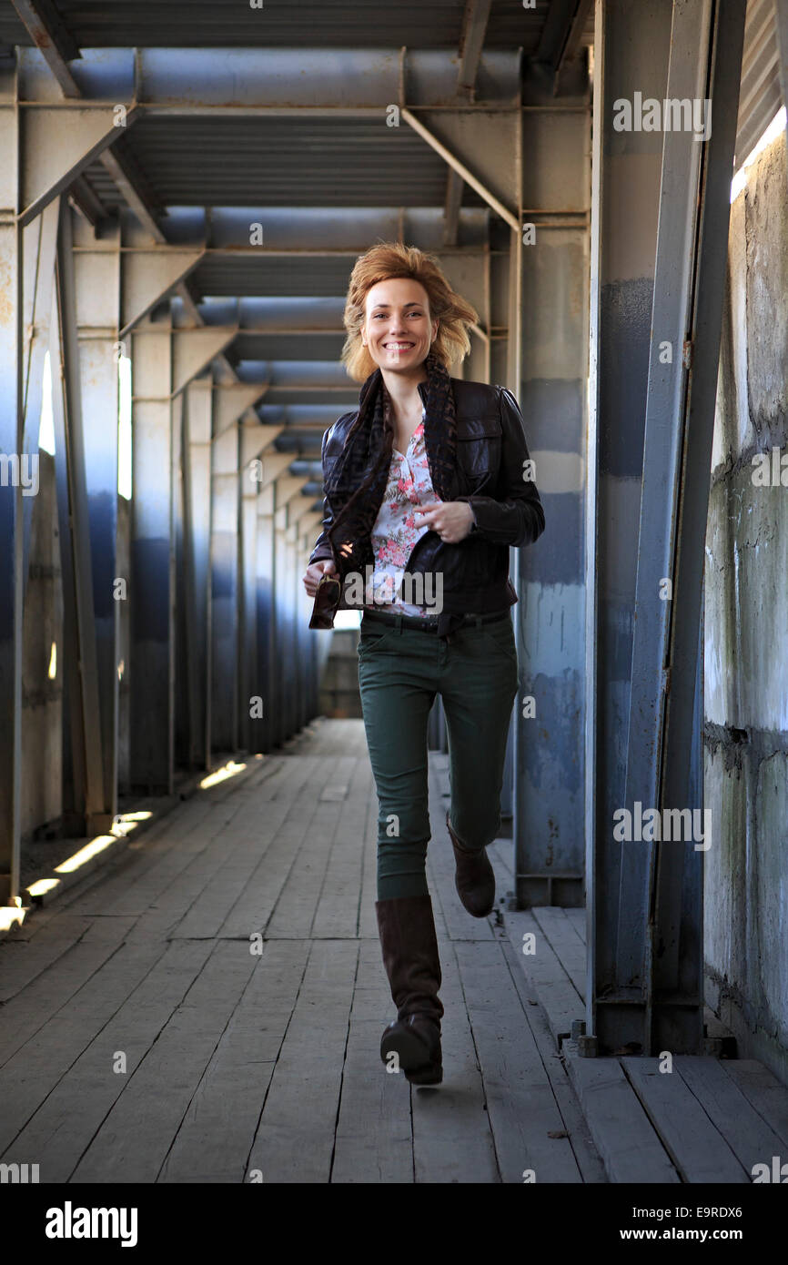 Beautiful girl running through transition Stock Photo - Alamy