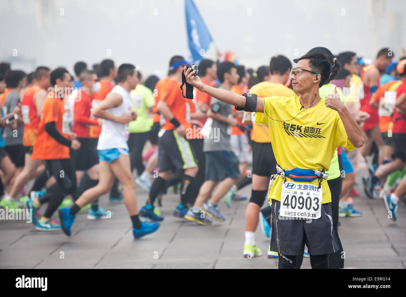 A runner takes a selfie in Tiananmen Square during the start of the ...