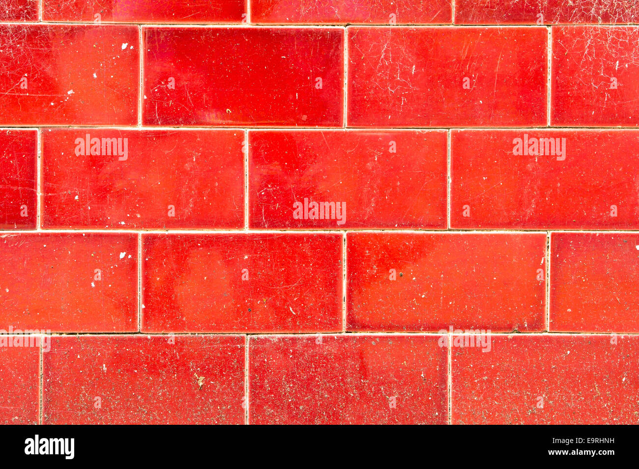 A weathered red tiled wall as a background Stock Photo - Alamy