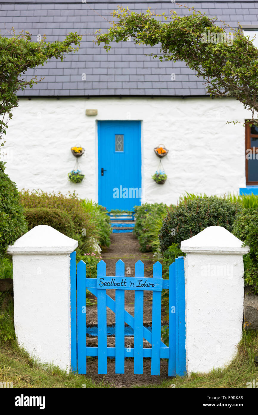 Traditional cottage with blue painted wooden front door and gate, slate ...