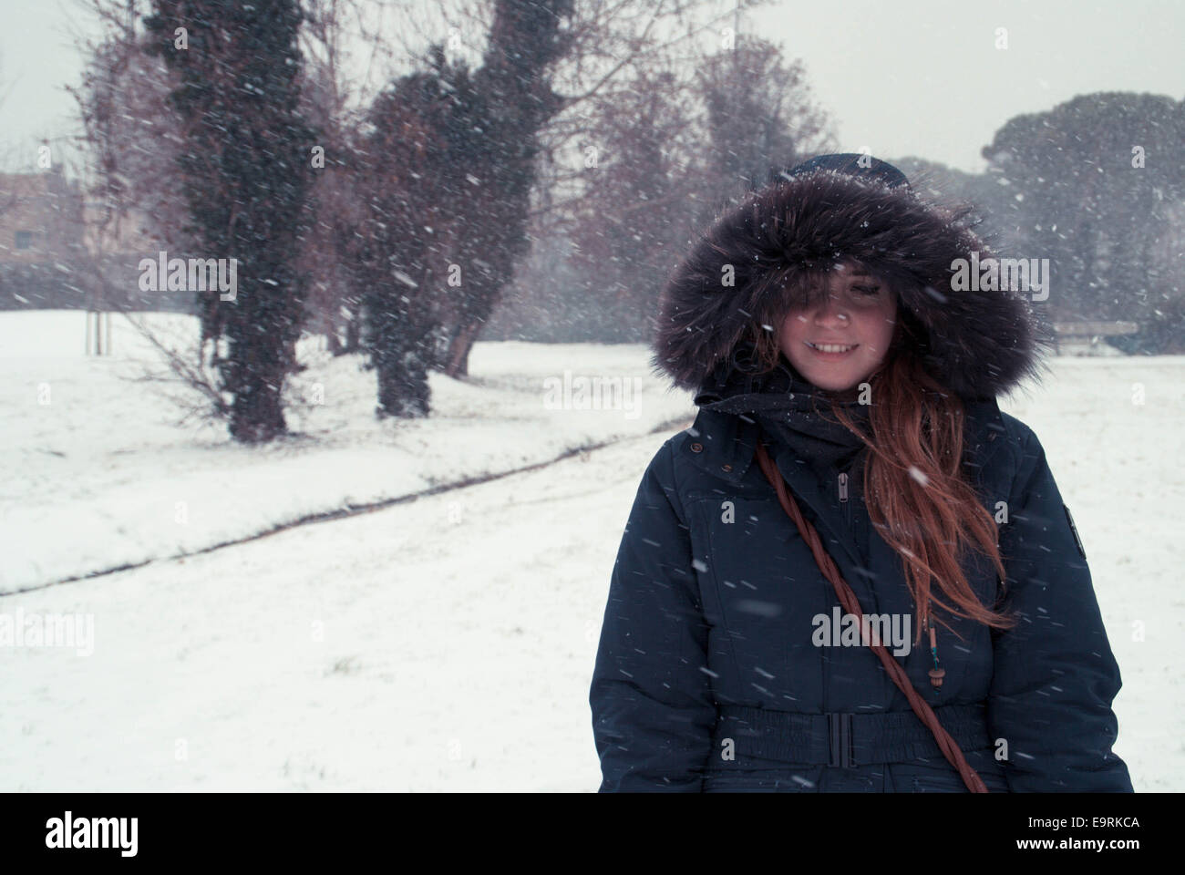 Girl under the snow in a park in winter, Rimini, Italy Stock Photo - Alamy