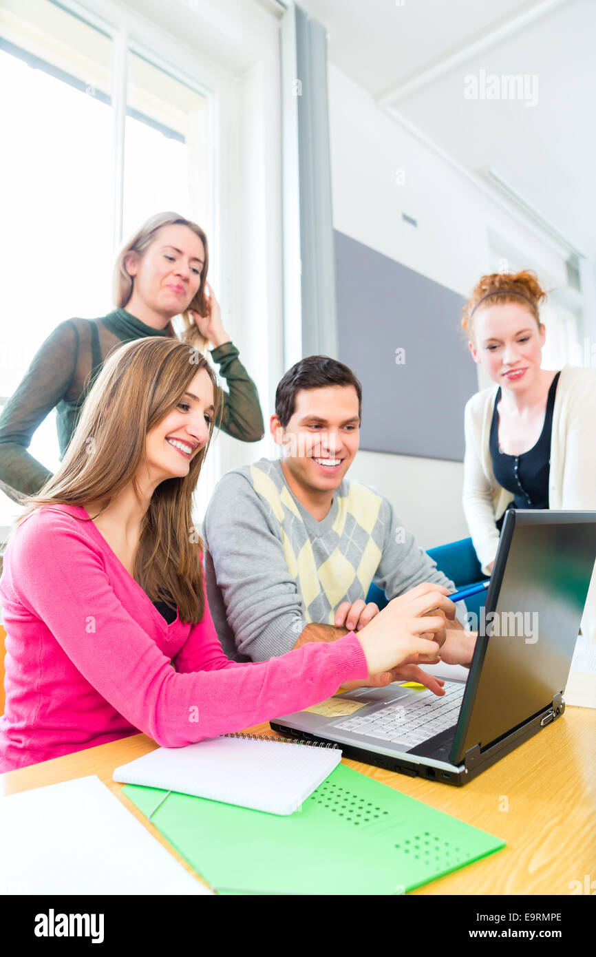 University college students using laptop for project team work learning ...