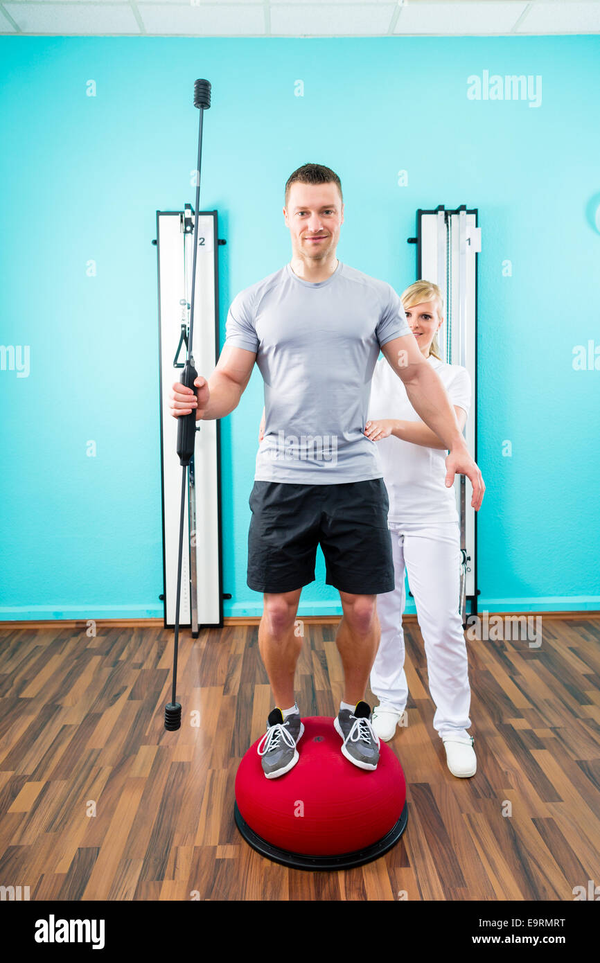 Patient at the physiotherapy doing physical exercises using flexi bar ...