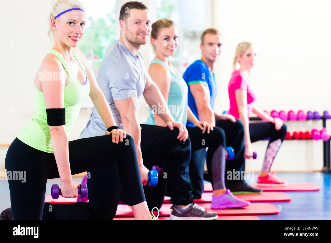 fitness people in gym working out with dumbbells Stock Photo - Alamy