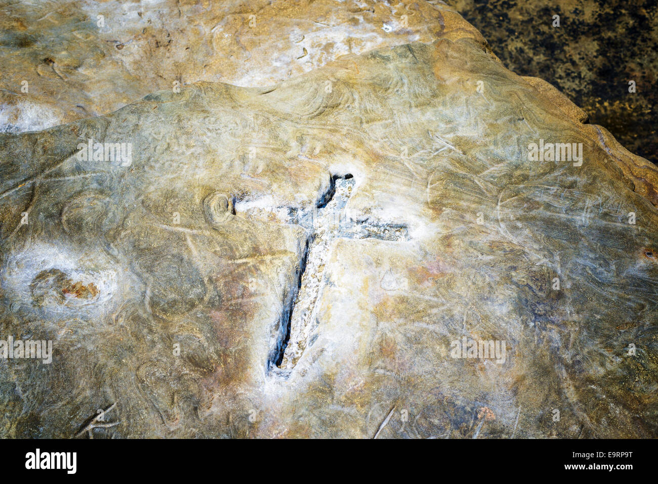 A cross shape carved into rock Stock Photo - Alamy