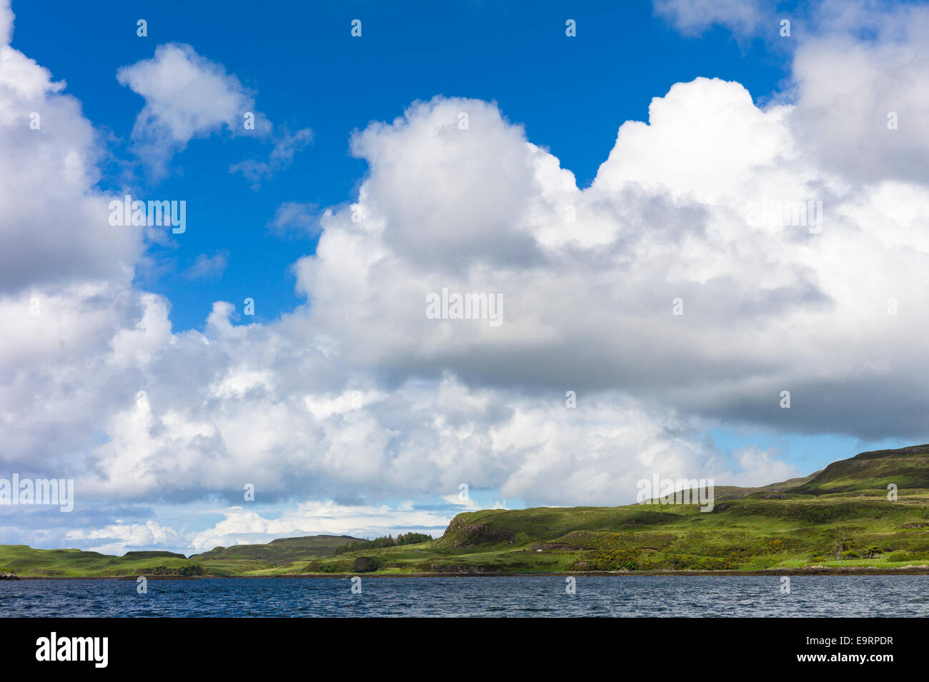 Puffy white Cumulus cloud formation above Dunvegan Loch, Isle of Skye ...