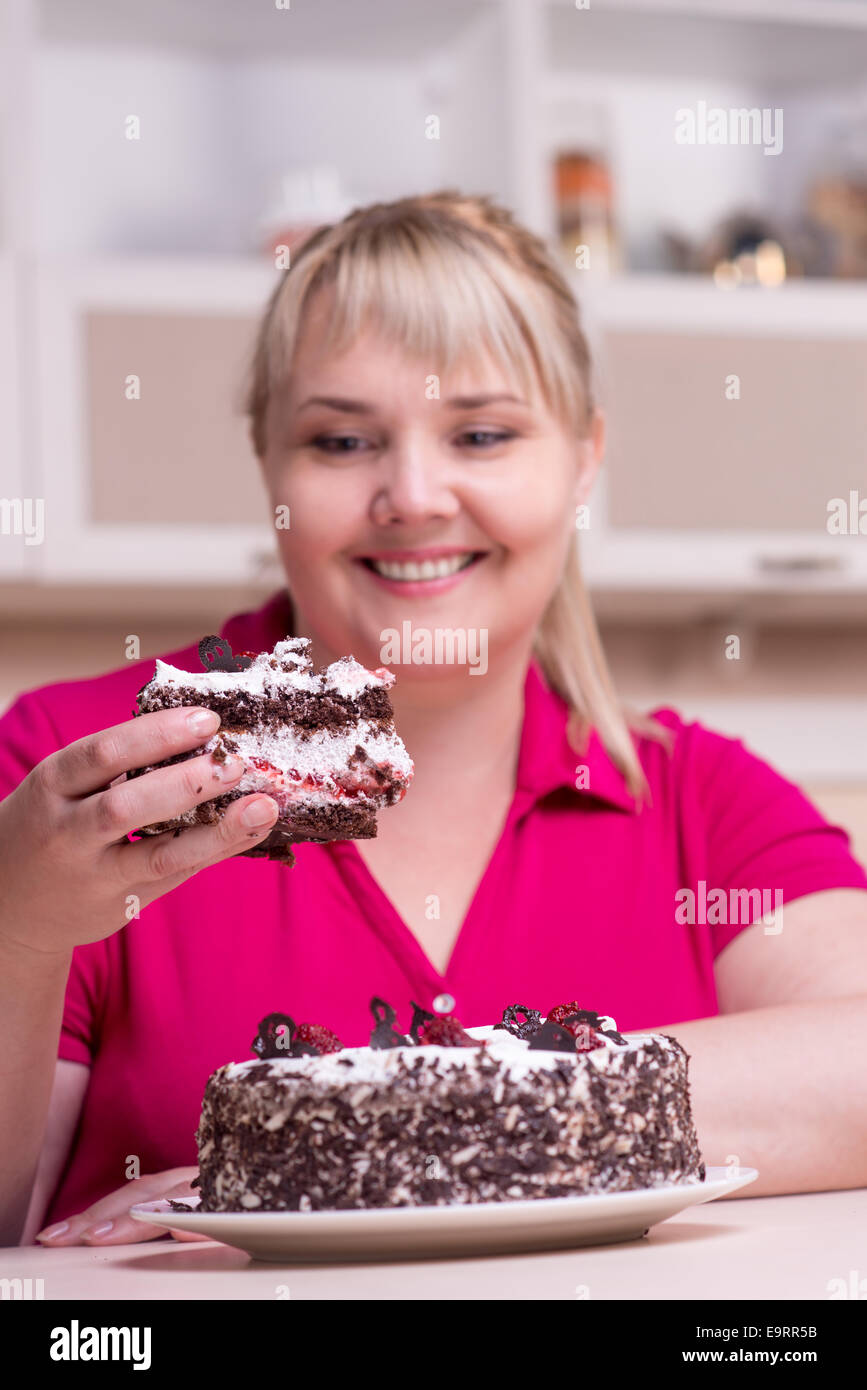 Young overweight woman wanting to eat big piece of cake Stock Photo - Alamy