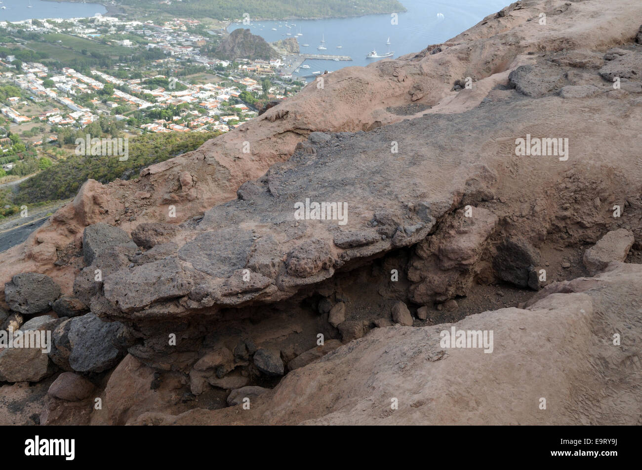 Thick red rock on the ridge of volcano crater on Vulcano Island above ...