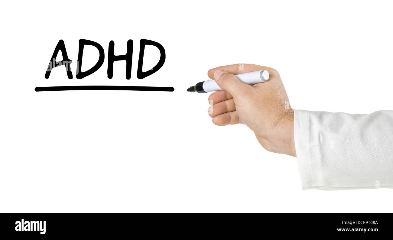 Hand with pen writing ADHD Stock Photo - Alamy