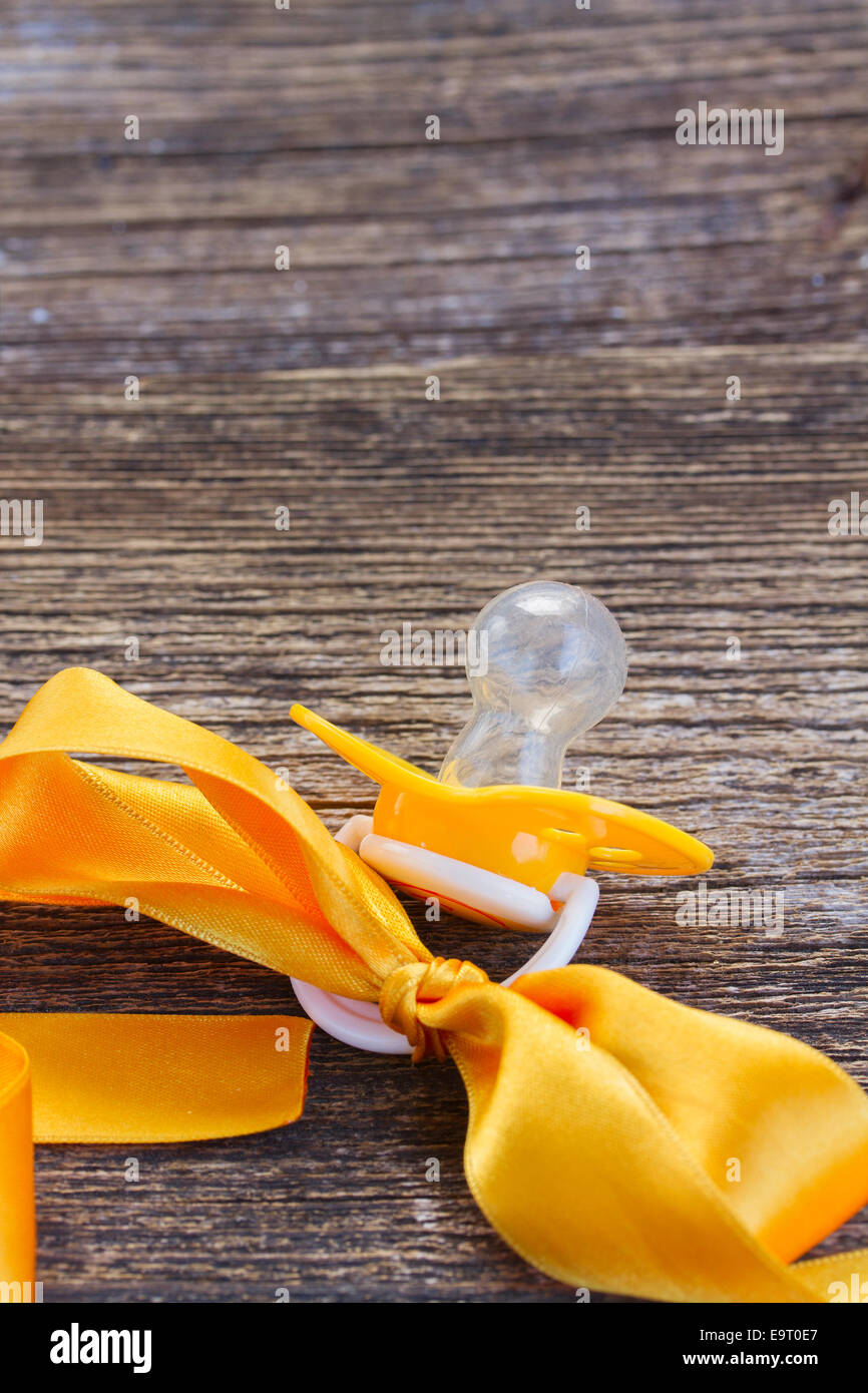 baby pacifier on wooden table Stock Photo - Alamy