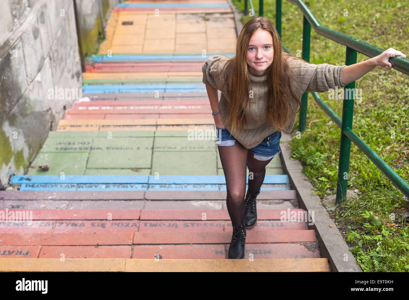 Young pretty girl on the stone steps in the city Stock Photo - Alamy