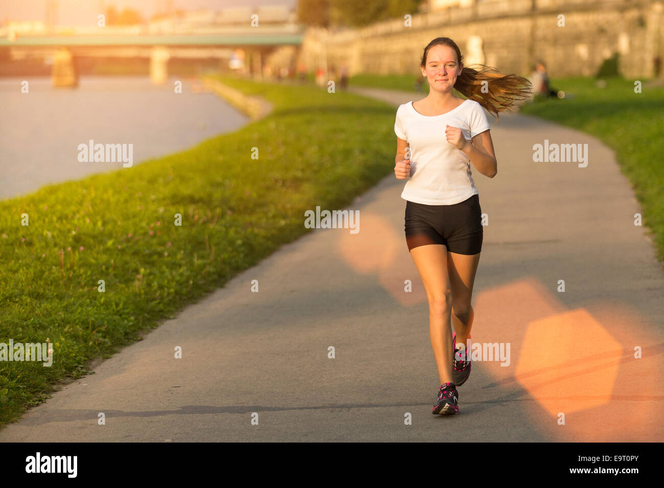 Cute fitness girl runner working out jogging. Running in the City Stock ...