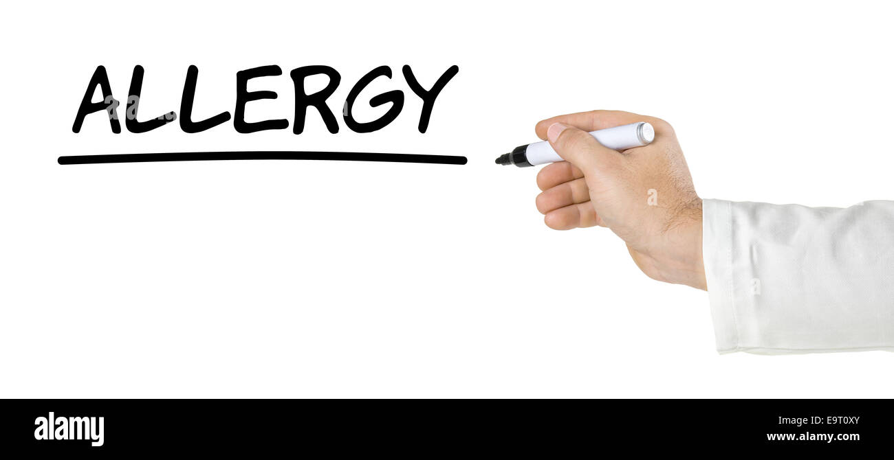 Hand with pen writing the word Allergy Stock Photo - Alamy