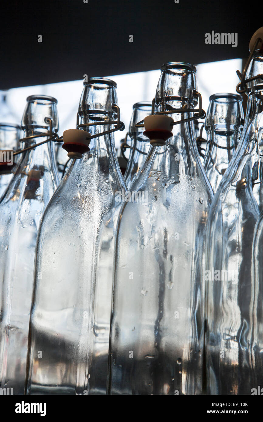 Stacked Glass Bottles in Restaurant Setting Stock Photo - Alamy