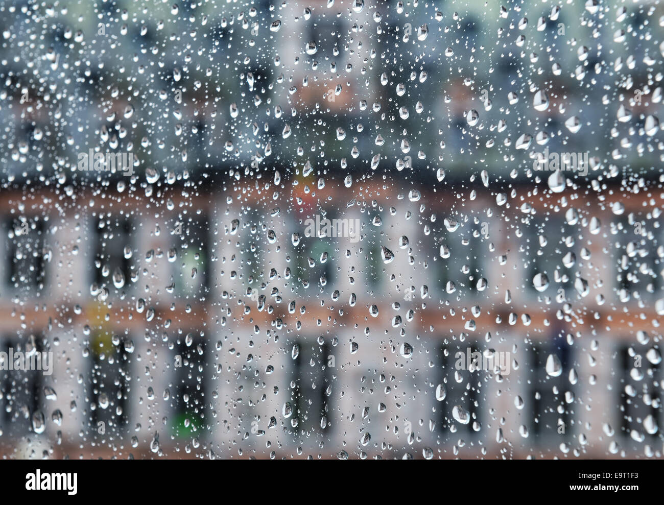 Medieval building visible through glass covered by rain drops Stock ...