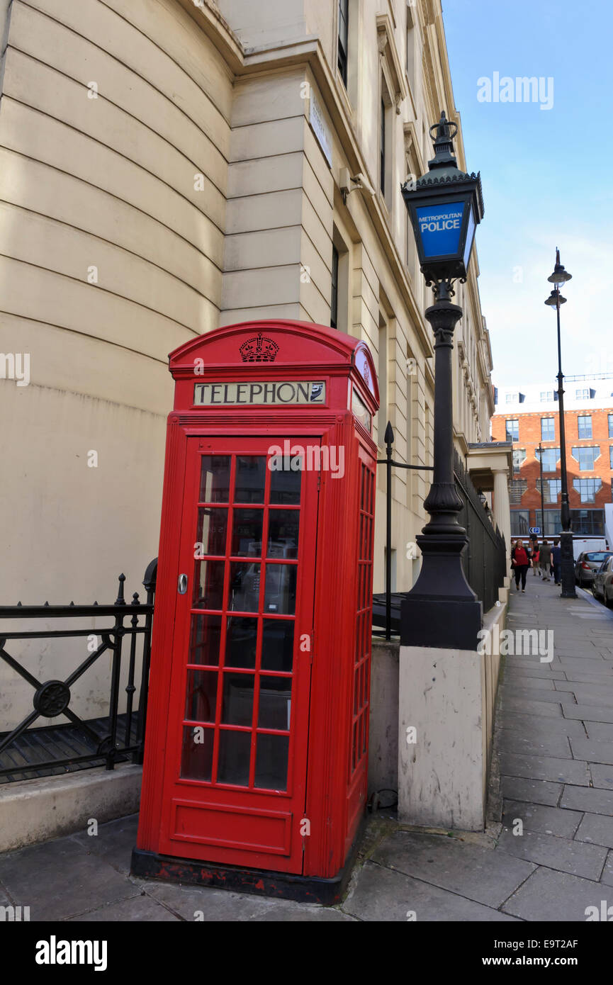 A traditional British red telephone box by an old Police lamppost in ...