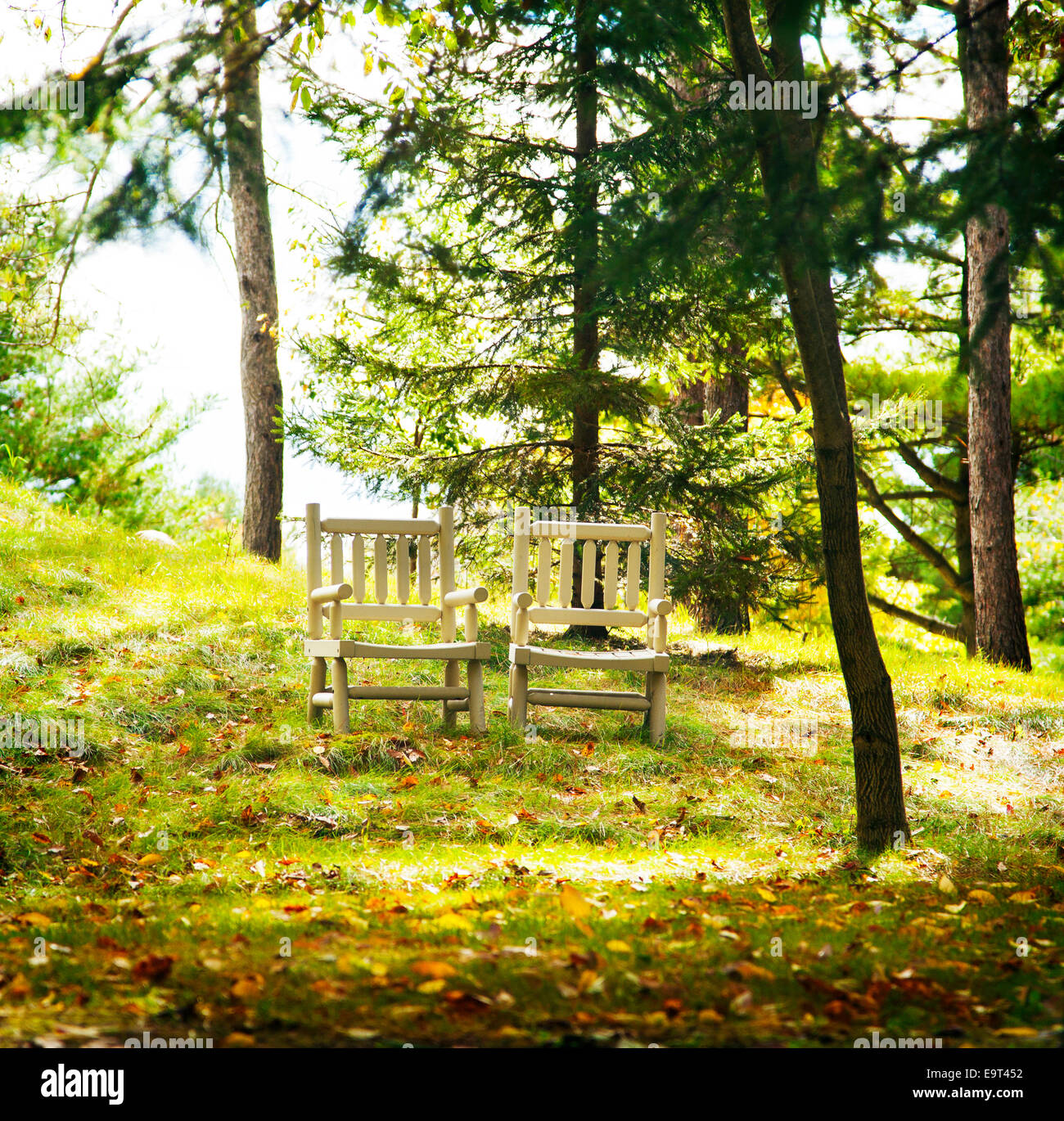 Two wooden chairs in nature. Autumn landscape Stock Photo - Alamy