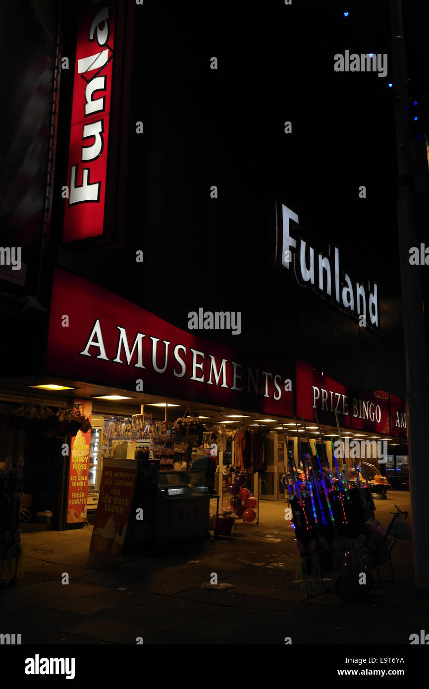 Night oblique view electric lights Funland Amusements Arcade, pavement ...