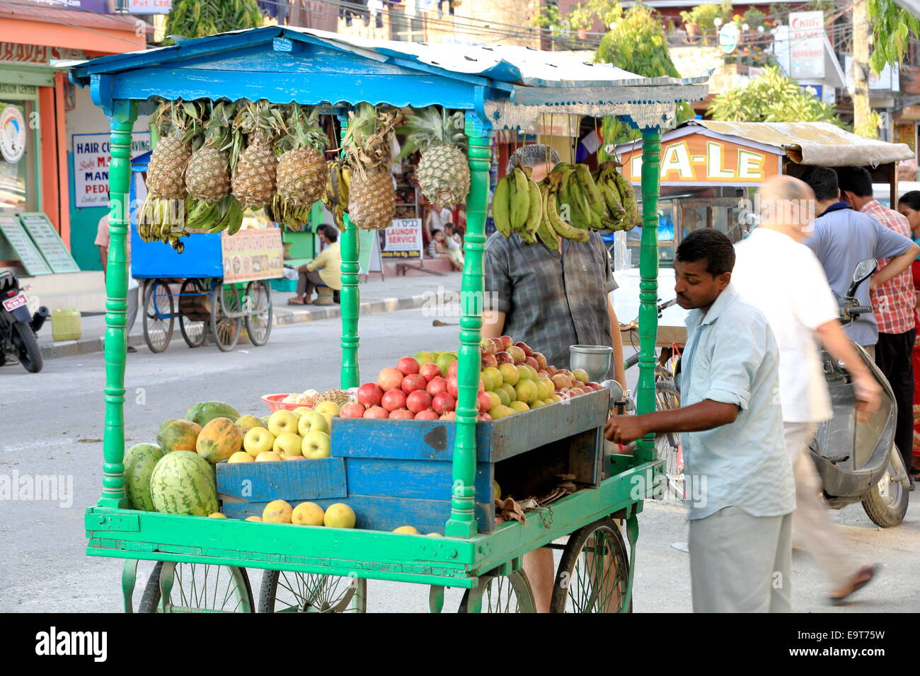 POKHARA, NEPAL - OCTOBER 11: Local salesman with a wheeled wooden stall ...
