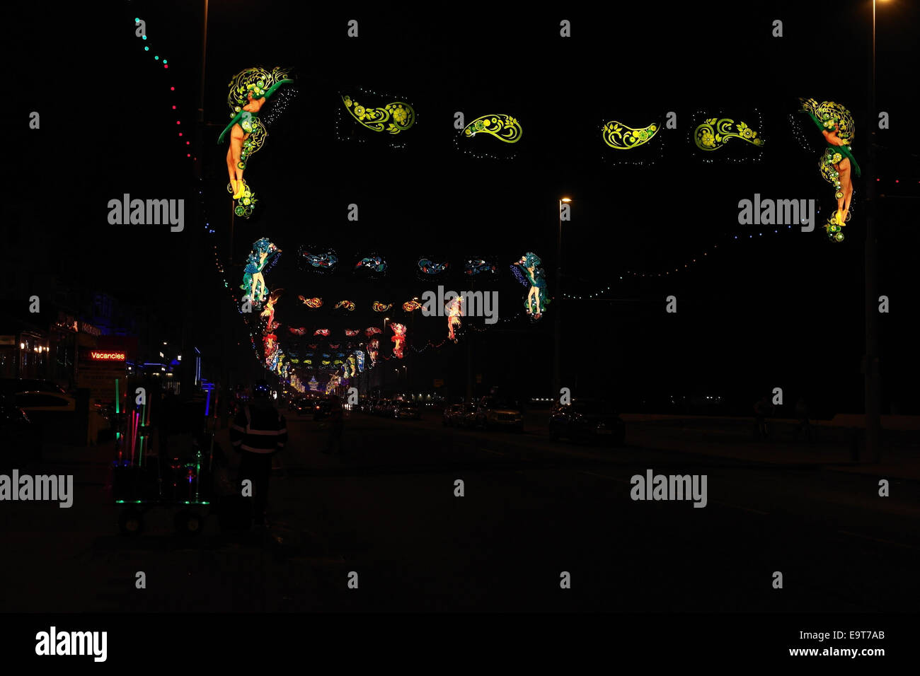 Night view man selling laser sticks, colourful Decodance burlesque ...