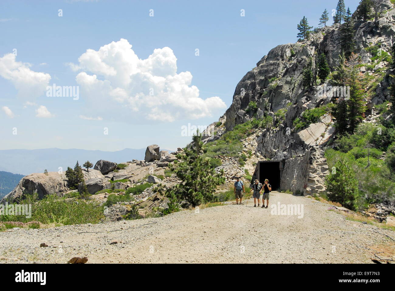Hikers near railroad snowshed and tunnel on Donner Pass in Sierra ...