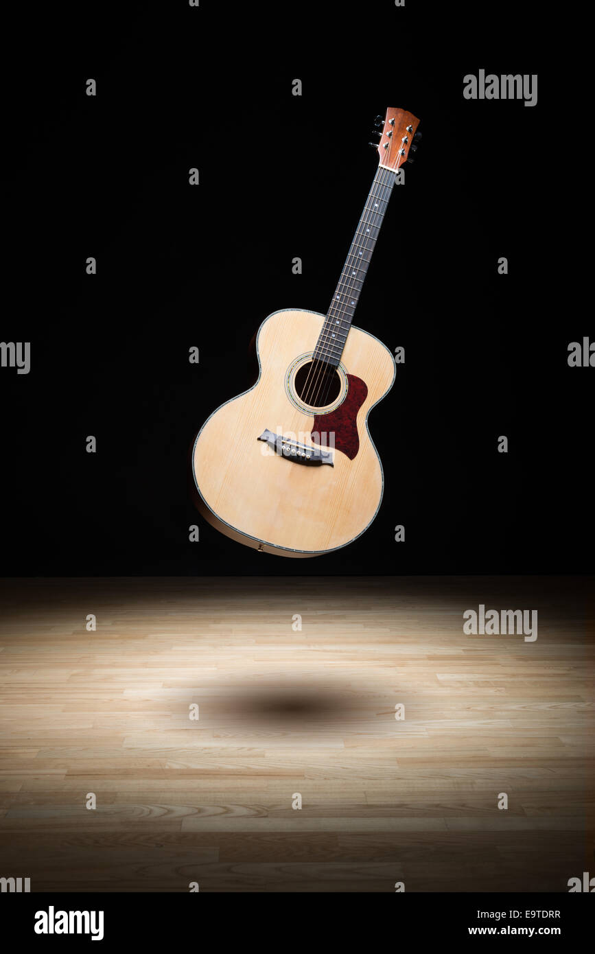Acoustic guitar floating in the air Stock Photo - Alamy
