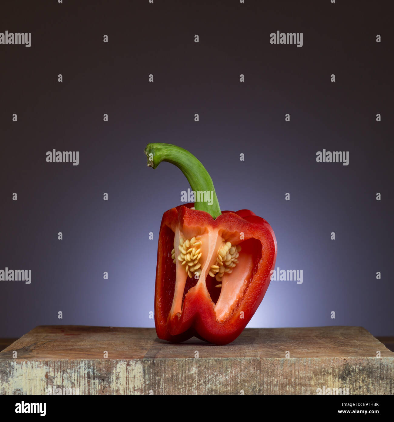a still life of a pepper with 2 sides cut open Stock Photo - Alamy