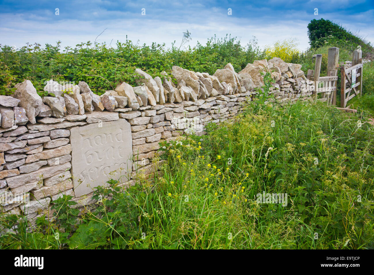 A plaque ("Hand Built Strata") in a dry stone wall on the South West ...