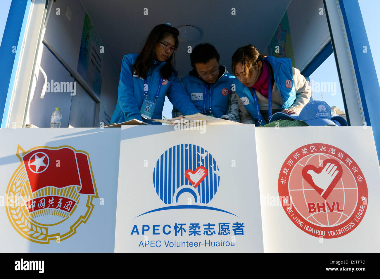 Beijing, China. 2nd Nov, 2014. Three volunteers work at an APEC service ...