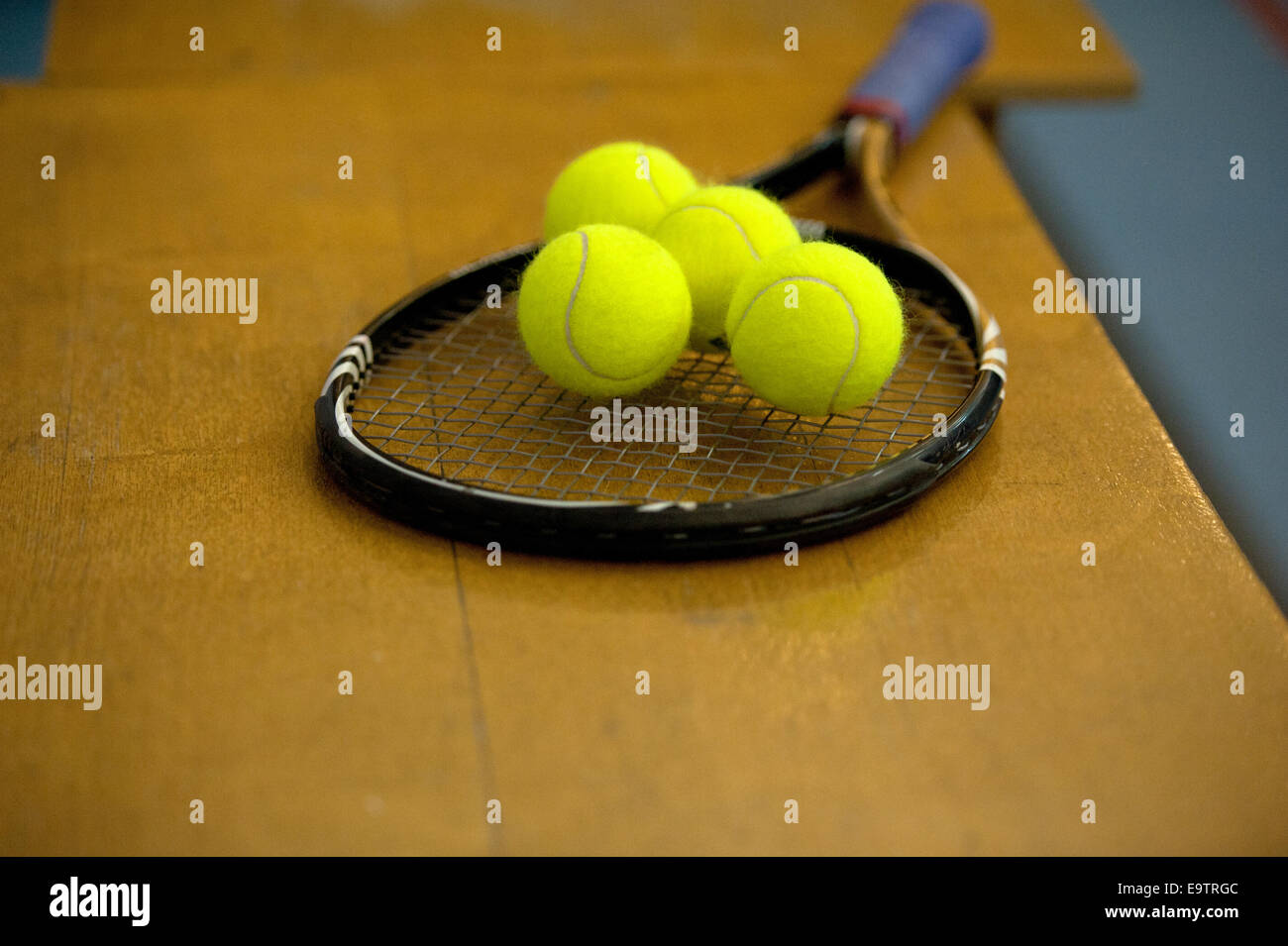 Tennis balls lying on a racket Stock Photo - Alamy