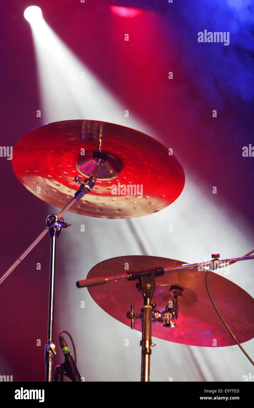 Two drum plates isolated on stage with light show in the background ...