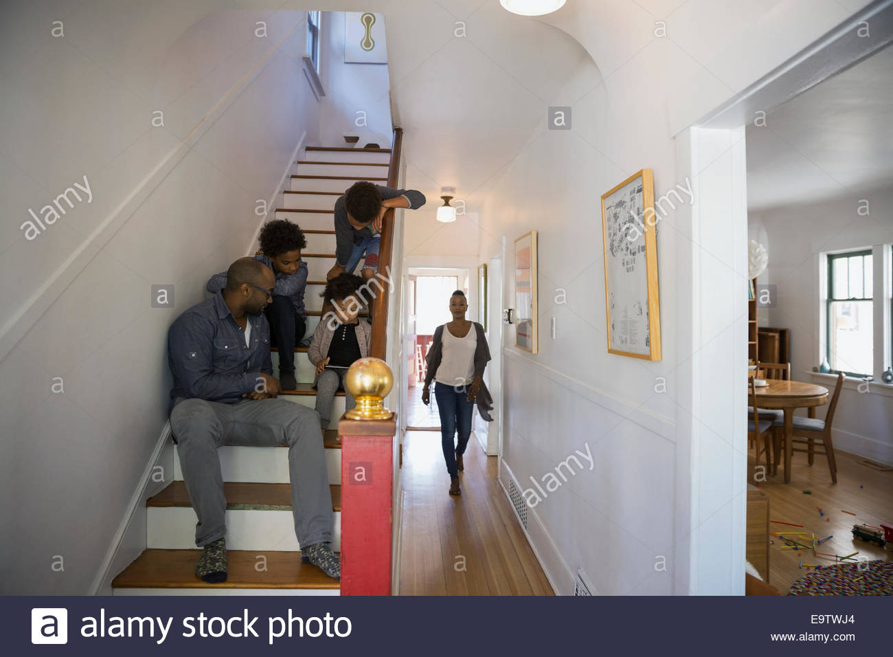 Family on stairs and in hallway Stock Photo - Alamy