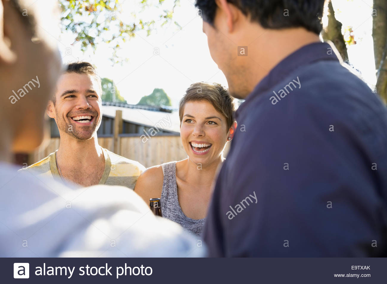Friends laughing and talking Stock Photo - Alamy