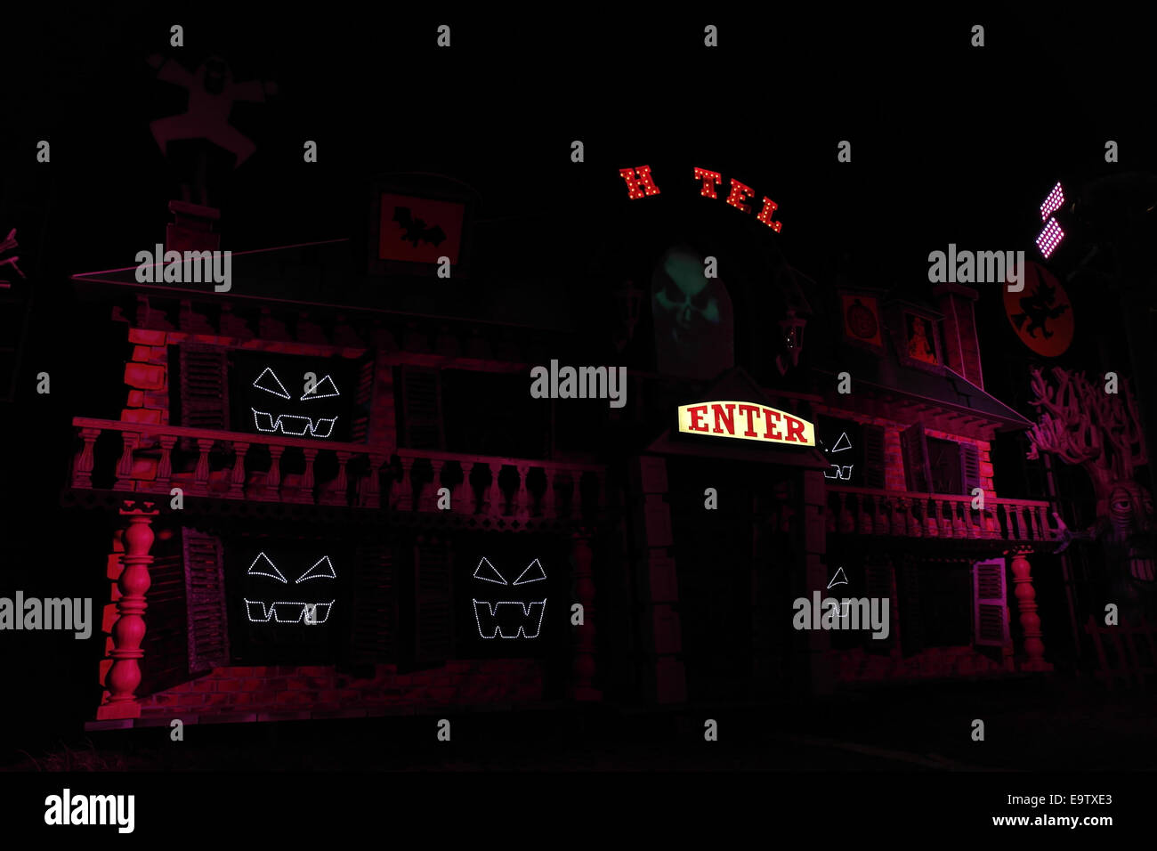 Night view red facade, Spooky Face image looking down, white neon ...