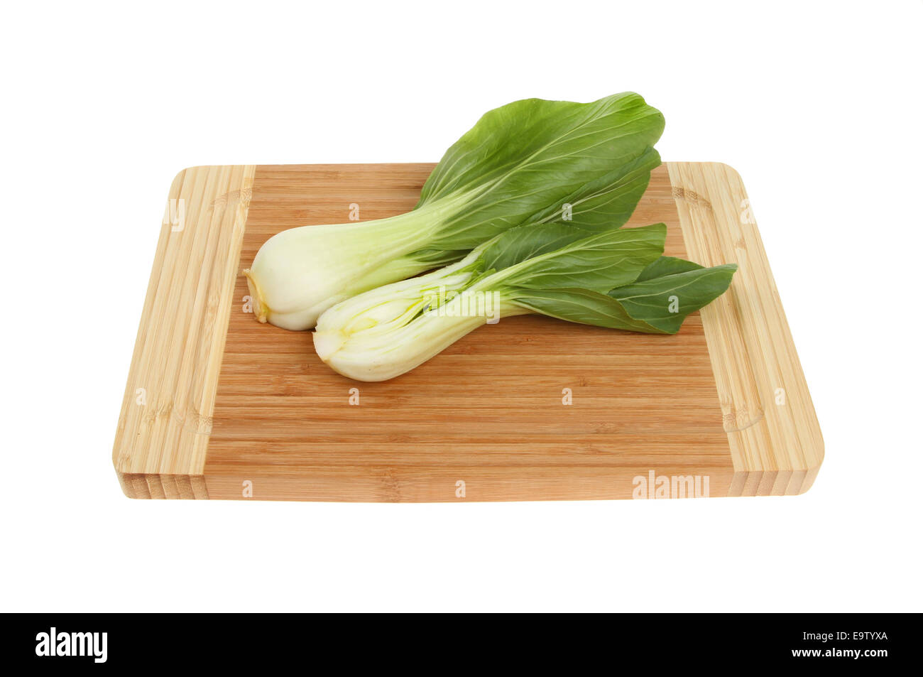 Cut Pak Choi, Chinese cabbage, on a bamboo chopping board isolated ...
