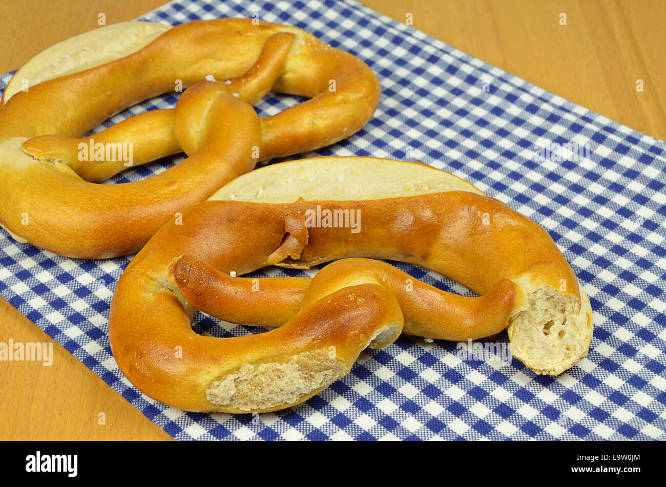two pretzels on a white and blue checkered napkin, close up Stock Photo ...