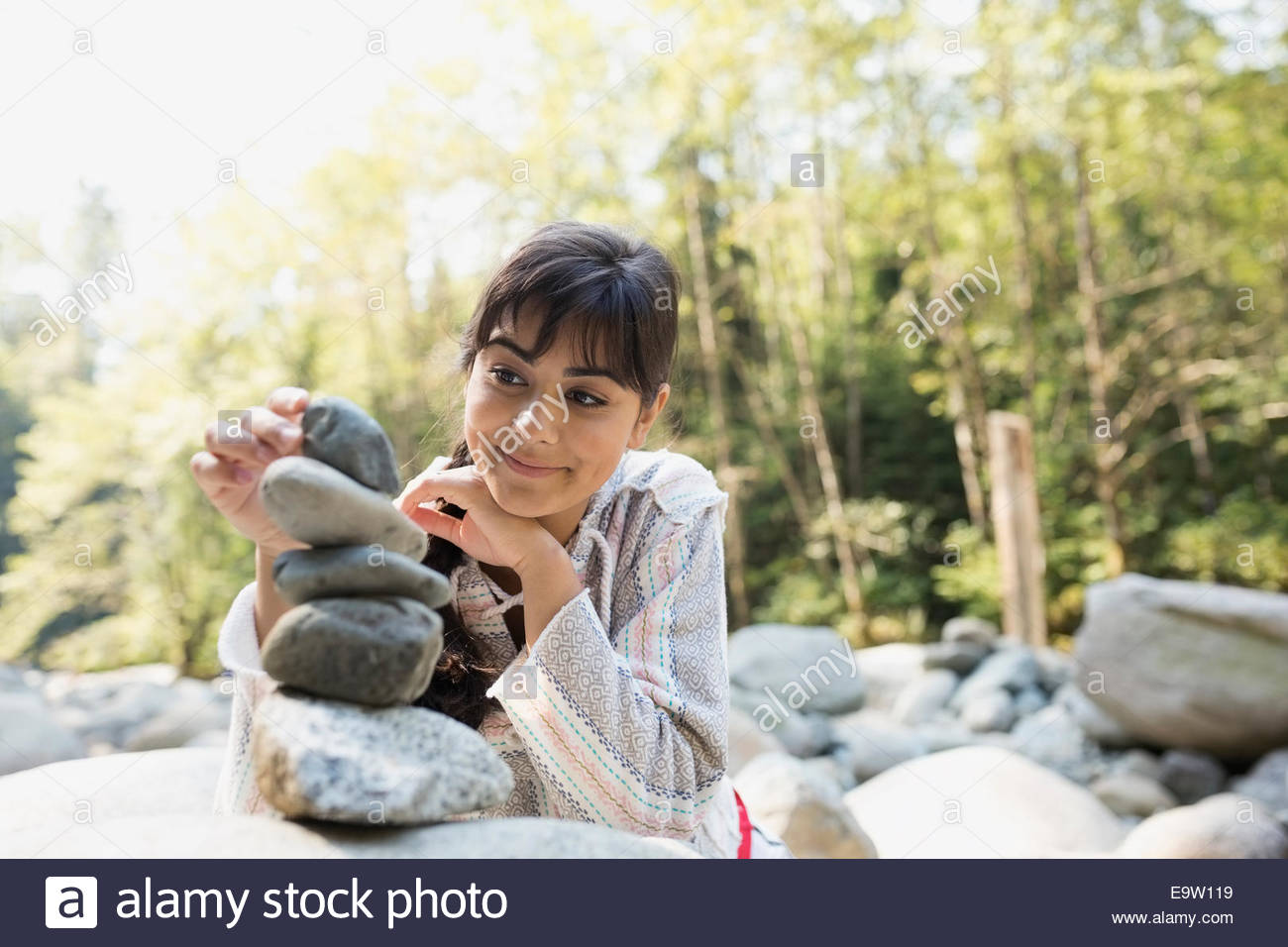 Woman leaning on rocks hi-res stock photography and images - Alamy