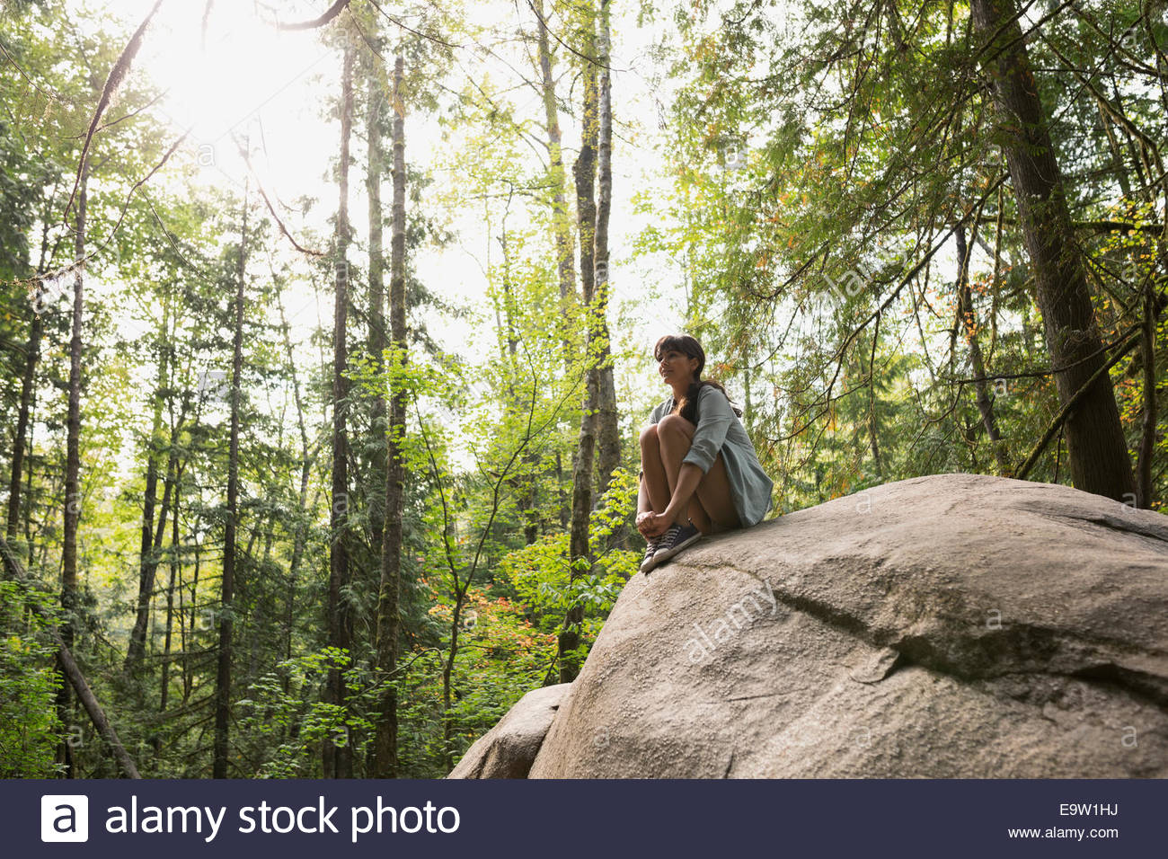 Women sitting on rock hi-res stock photography and images - Alamy