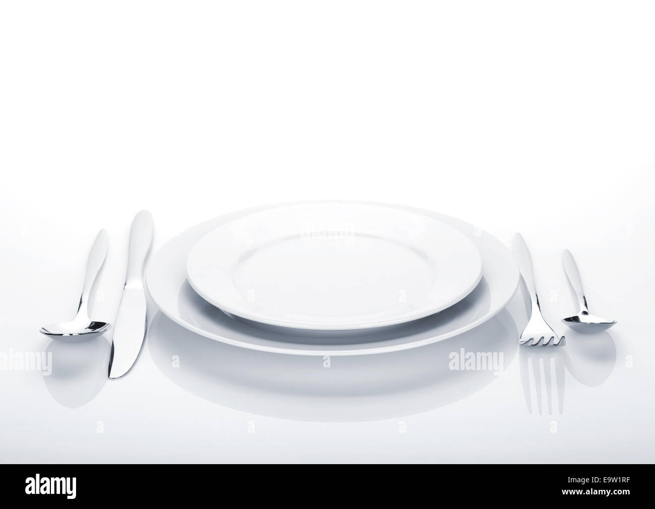 Silverware or flatware set and plates. Isolated on white background ...