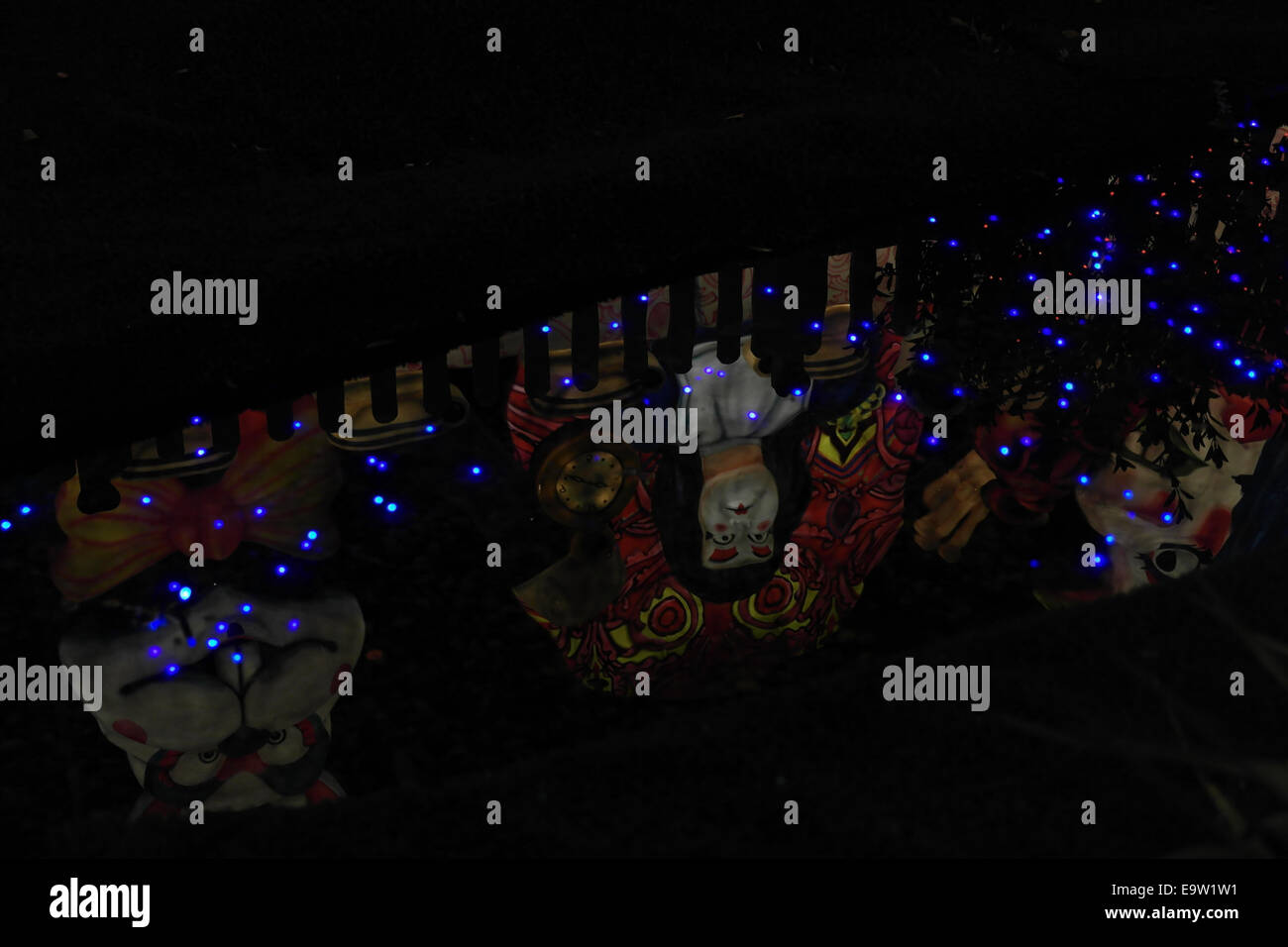 Night view Alice next to Cheshire Cat, March Hare reflecting in water ...