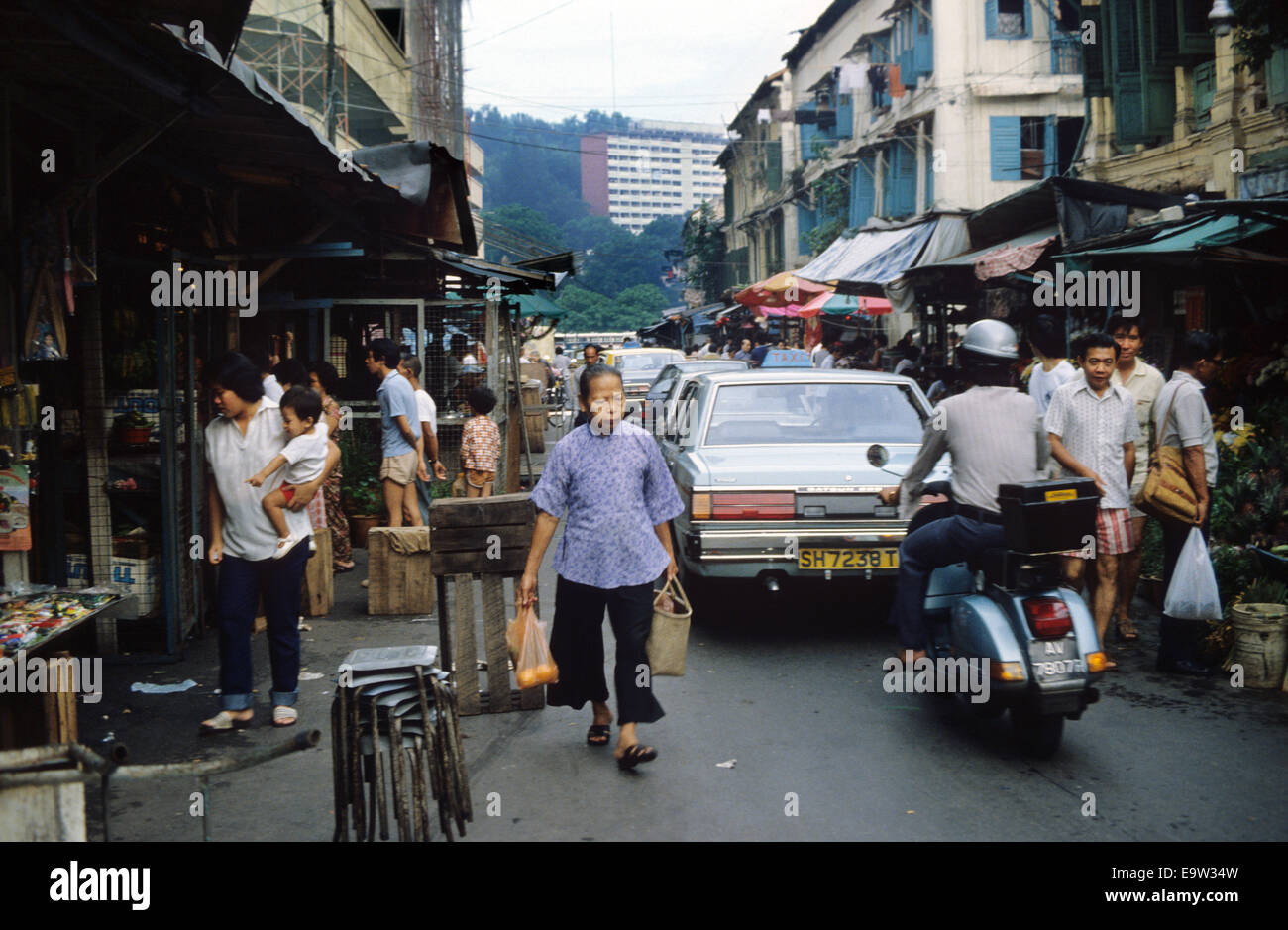 Singapore City, street scene in the late 1970s. Shoppers, motorists and ...