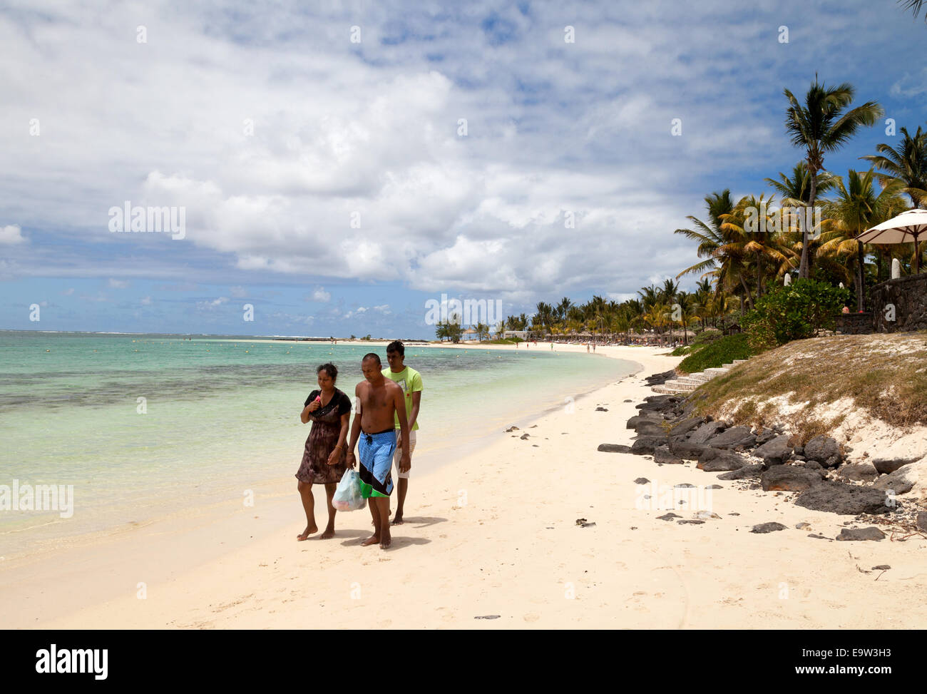 Local mauritian people walking on Belle Mare beach, east coast ...