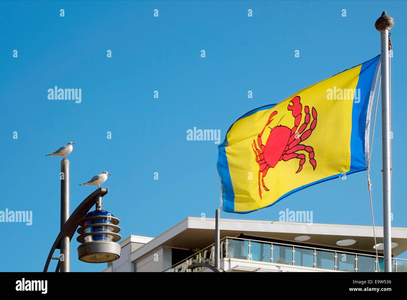 yellow flag depicting a red crab flying above a stall selling fresh ...