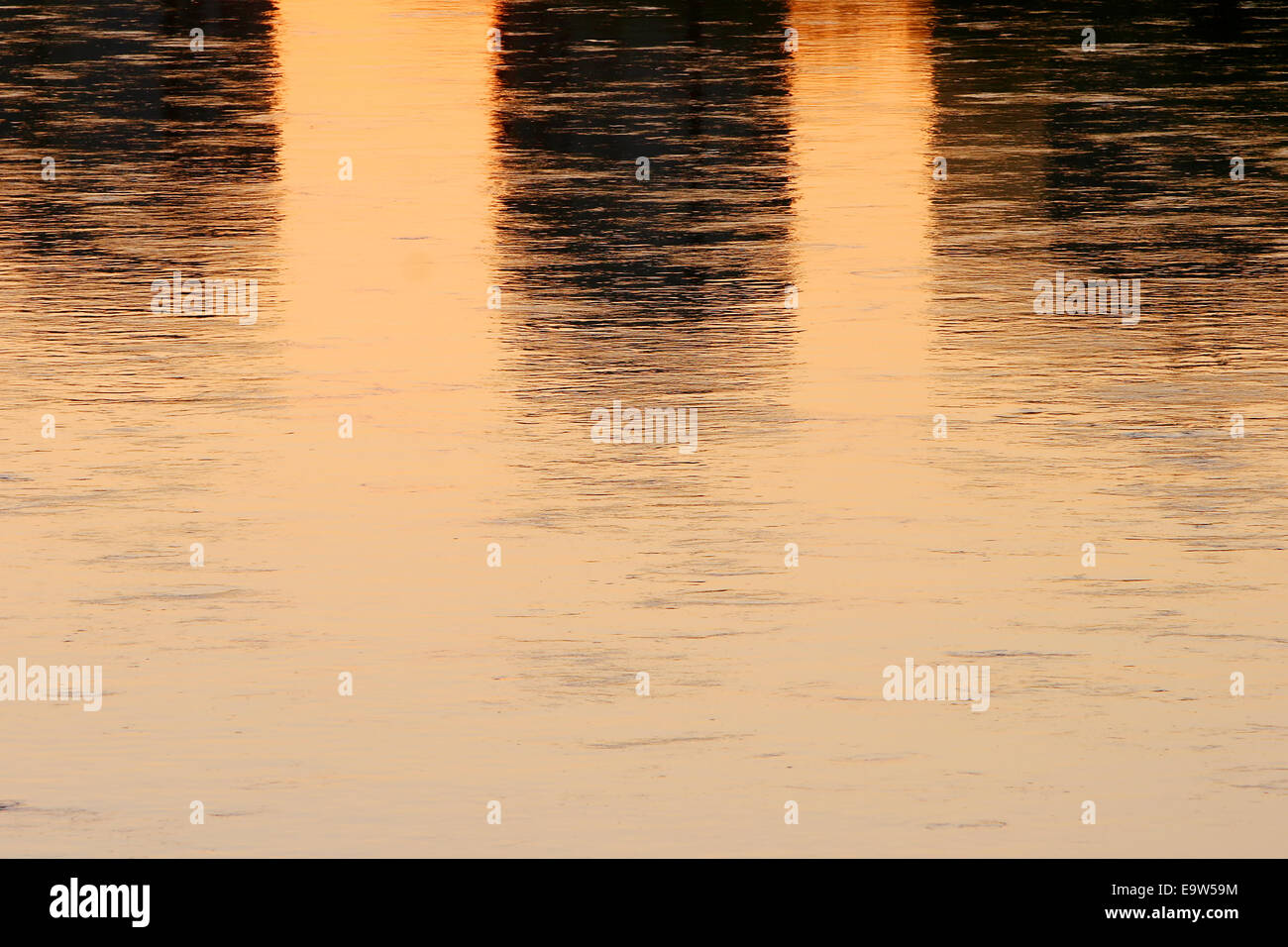 Sunlight and skyscraper reflection on the water surface of river Stock ...