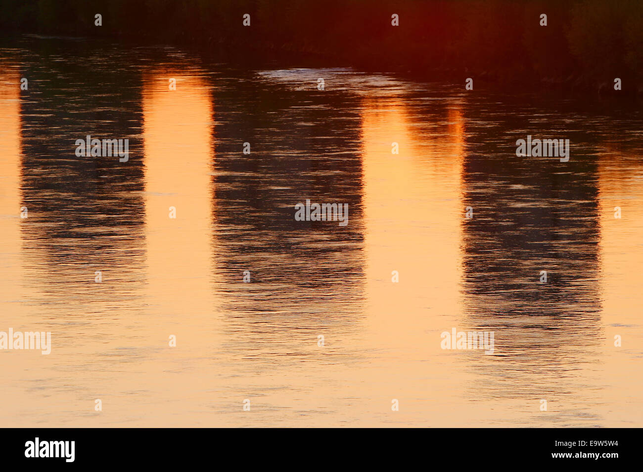 Sunlight and skyscraper reflection on the water surface of river Stock ...